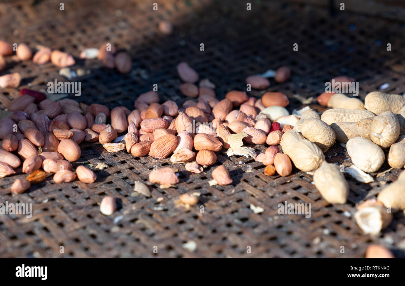 raw peeled peanuts on old bamboo basket Stock Photo - Alamy
