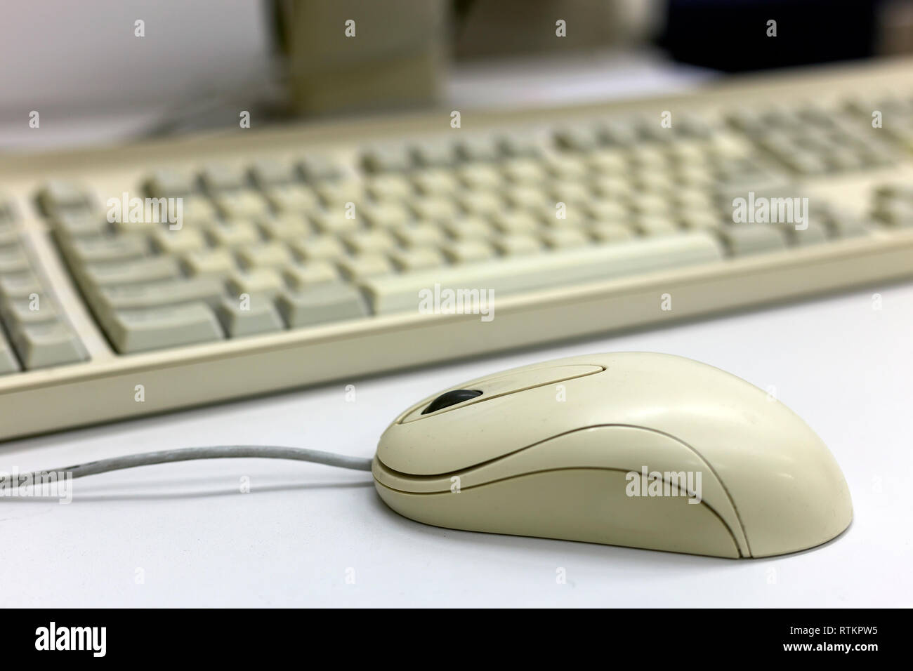 Close-up of white computer mouse on blurred PC keyboard background ...