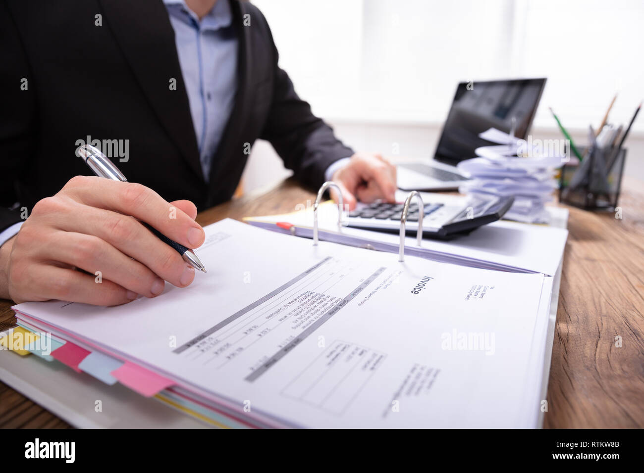 Male Accountant Calculating Invoice With Calculator In Office Stock ...