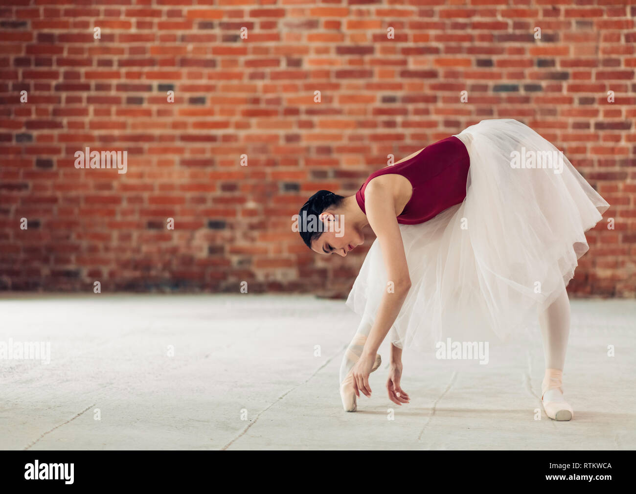 young attractive dancer having fun in the loft studio, full length side ...