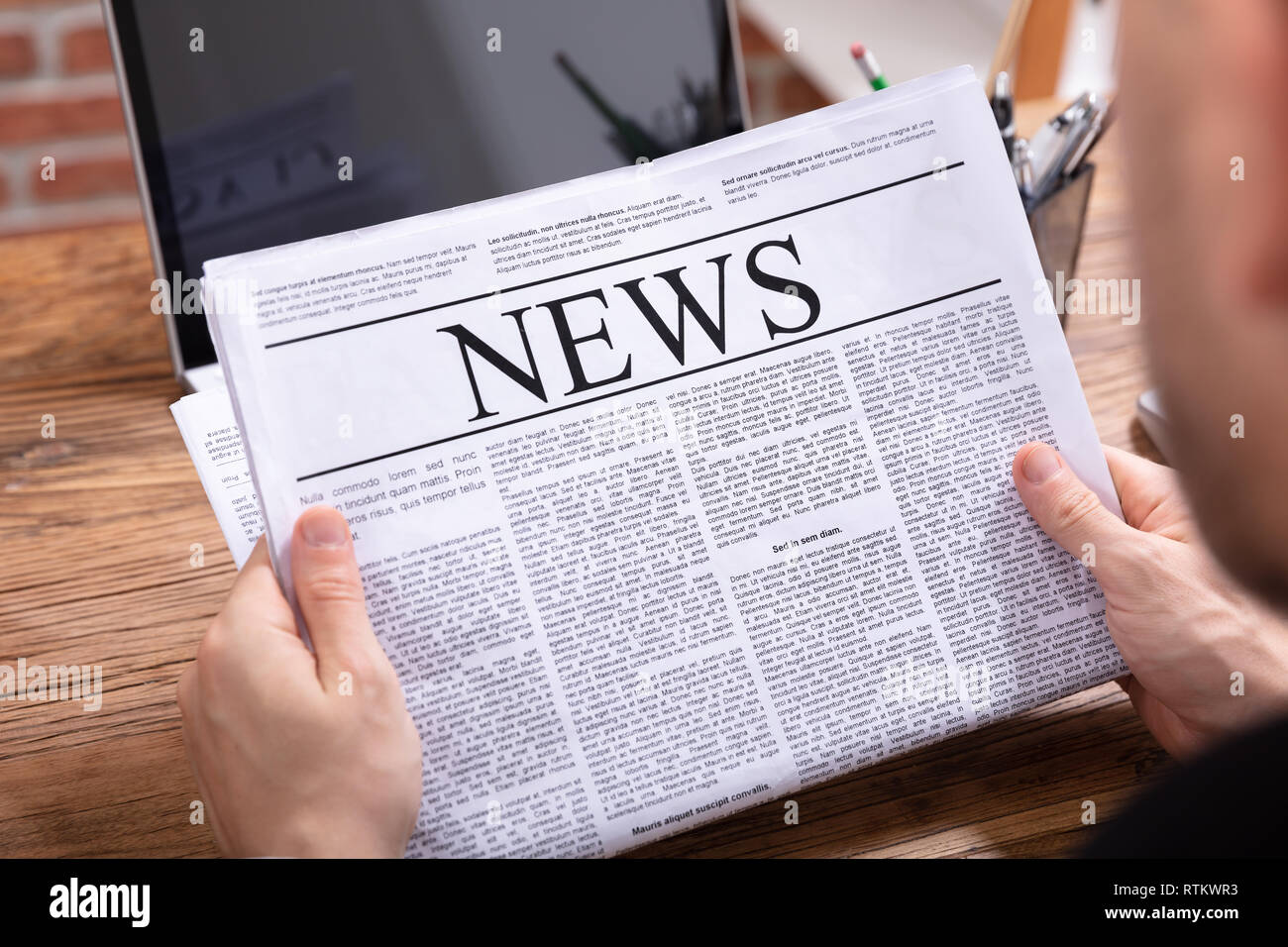 Man in office reading newspaper hi-res stock photography and images - Alamy