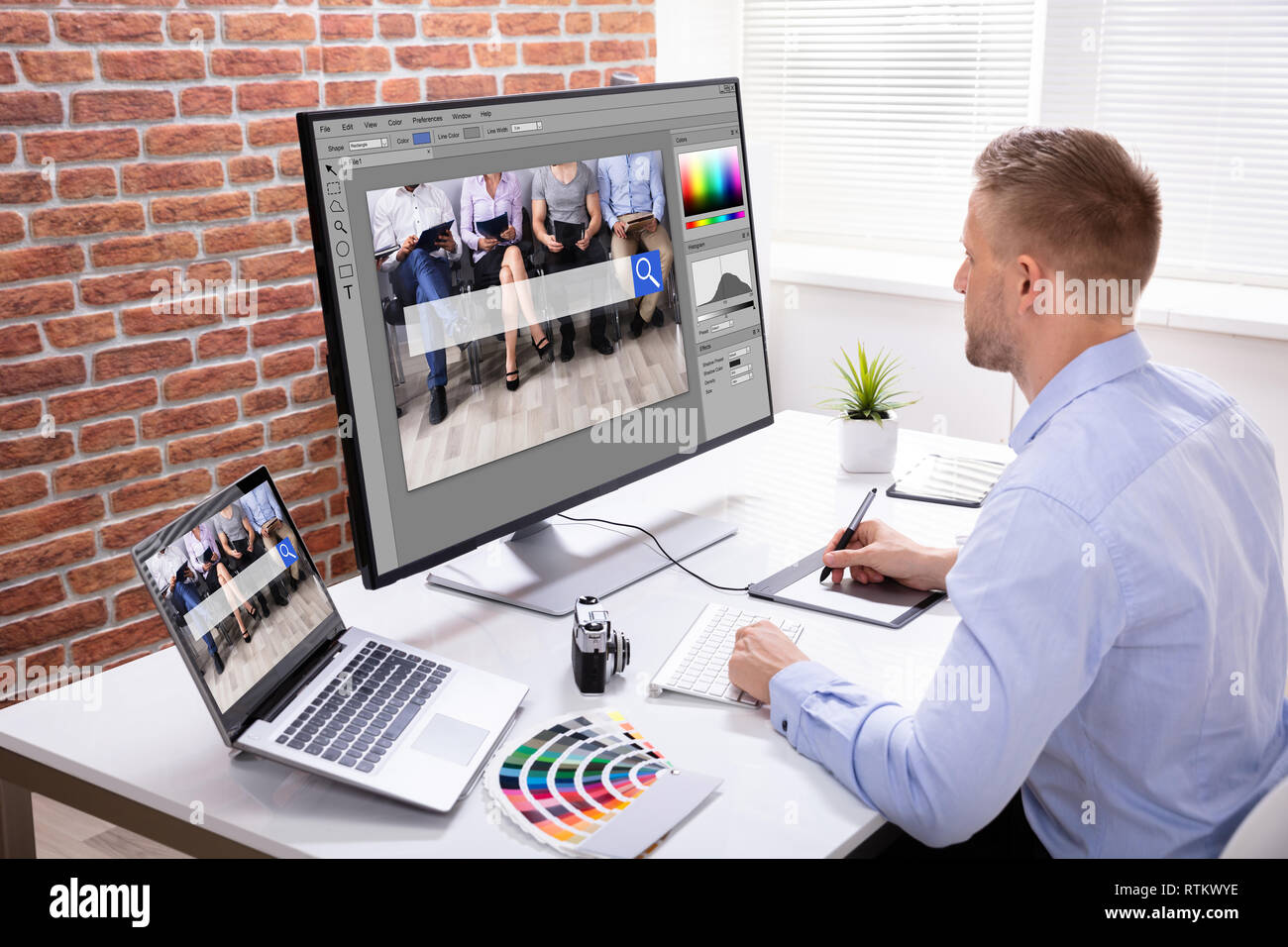 Male Designer's Hand Using Graphic Tablet While Working On Multiple ...