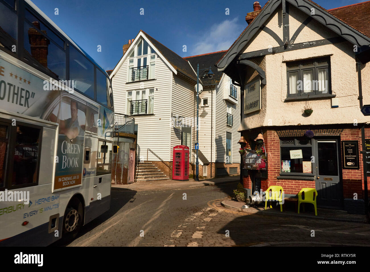 Colourful Canterbury bus driving through Whitstable street, Kent ...