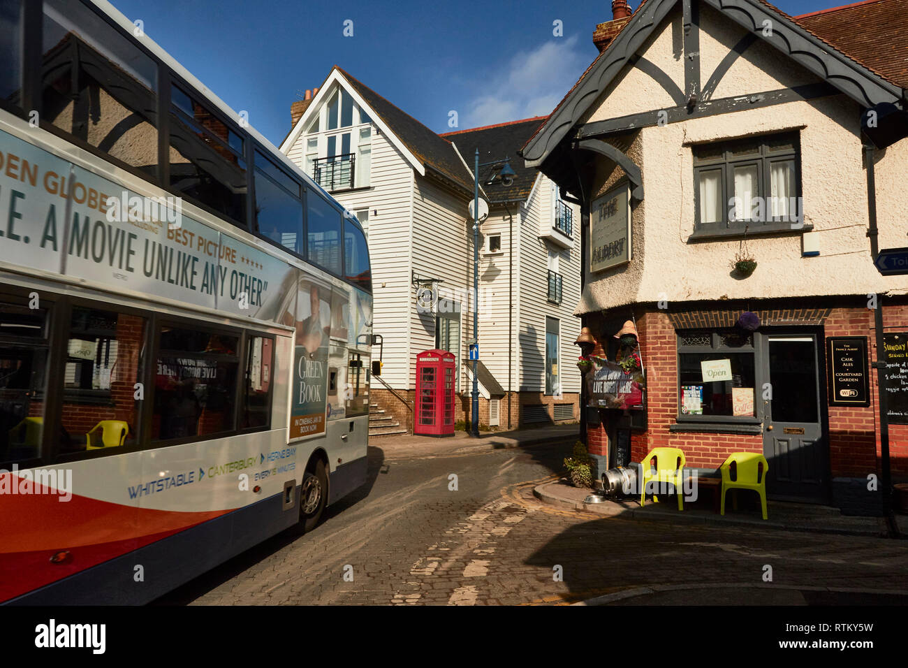 Colourful Canterbury bus driving through Whitstable street, Kent ...