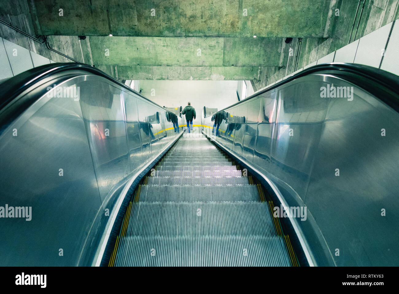 Metro escalator in Montreal, Canada - man going down Stock Photo - Alamy