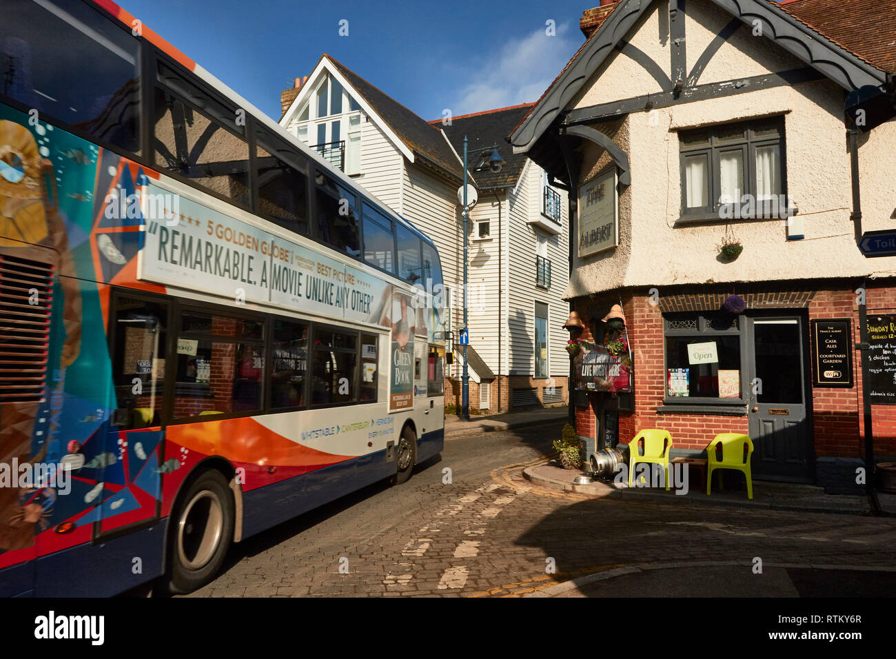 Colourful Canterbury bus driving through Whitstable street, Kent ...