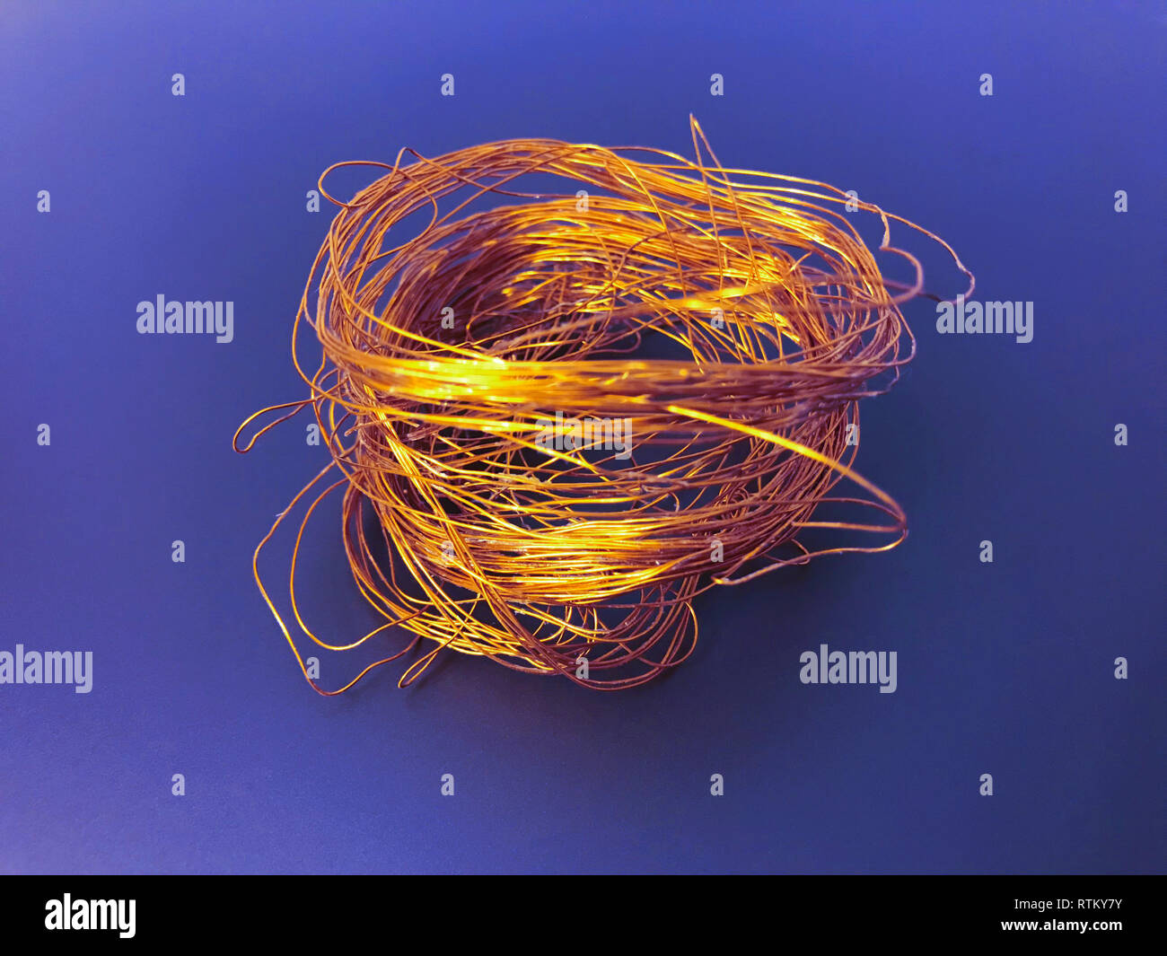 Hank of the cooper wire on a blue background Stock Photo - Alamy