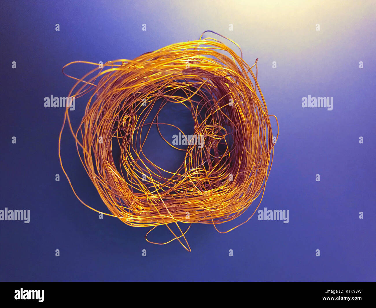 Hank of the cooper wire on a blue background Stock Photo - Alamy