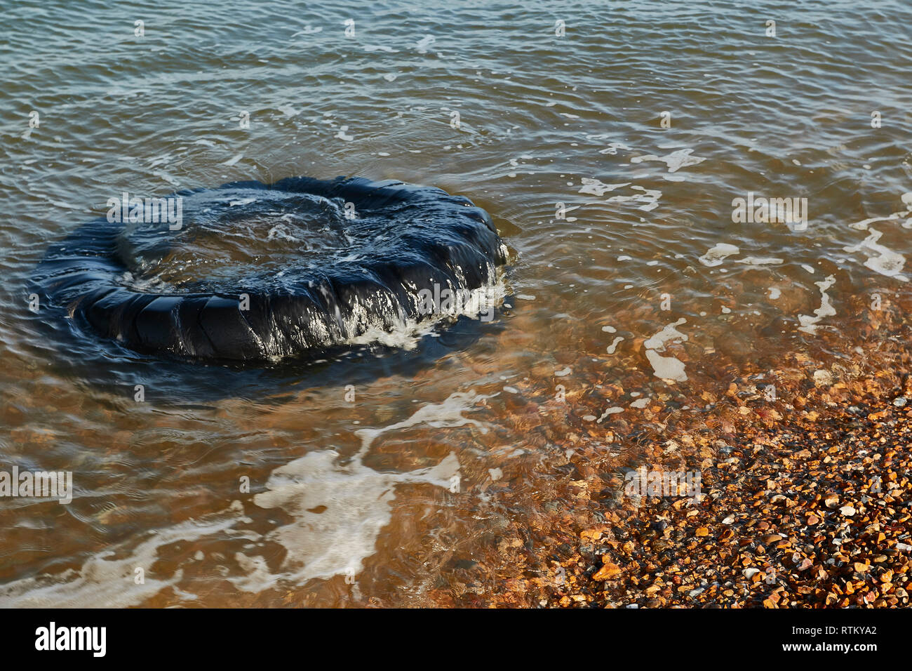 Tyre in the sea off Whitstable, still-life Stock Photo - Alamy