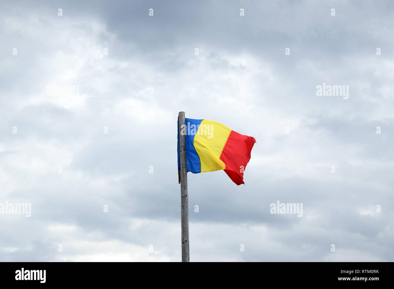 Romanian flag waving in the wind in front of a clean blue sky. Romania ...