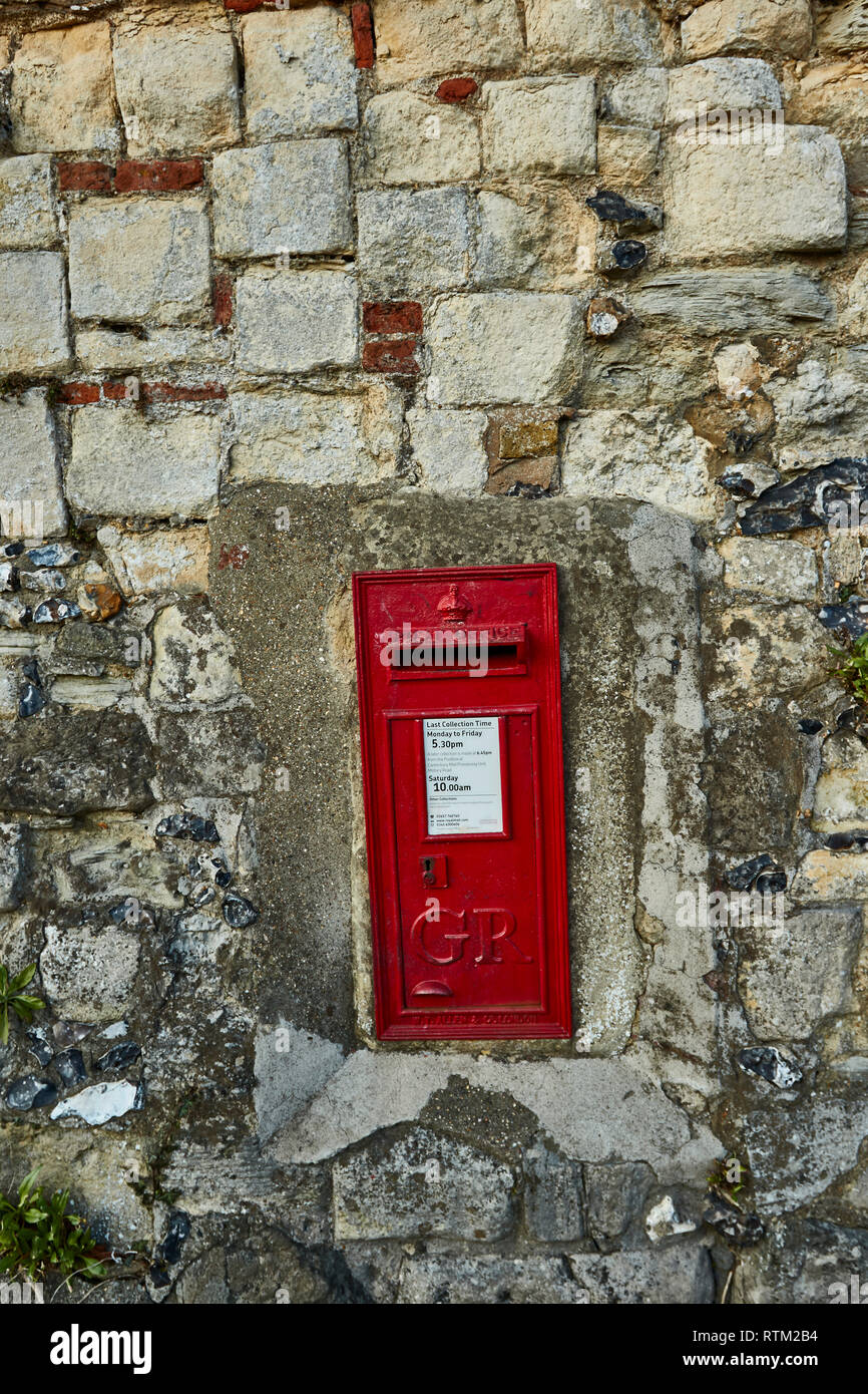 Red postal box built into stone wall, Canterbury, Kent, England, United ...
