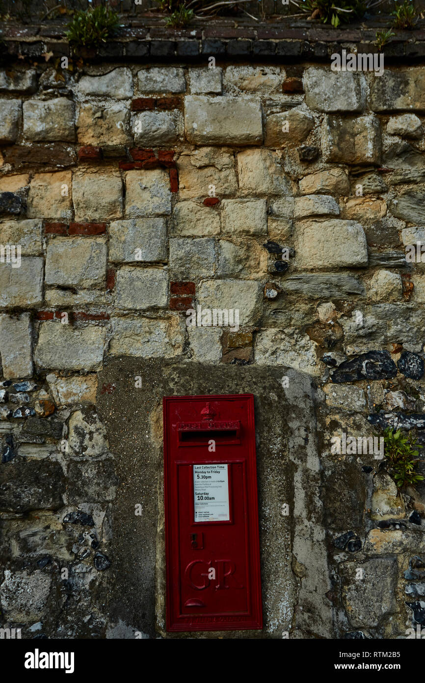 Red postal box built into stone wall, Canterbury, Kent, England, United ...