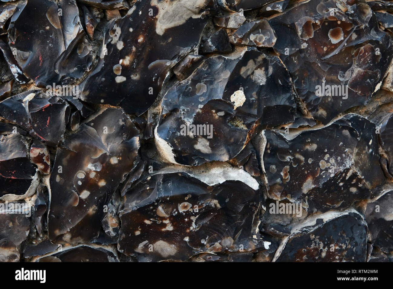 Flint rock abstract pattern built into a wall in southern England ...