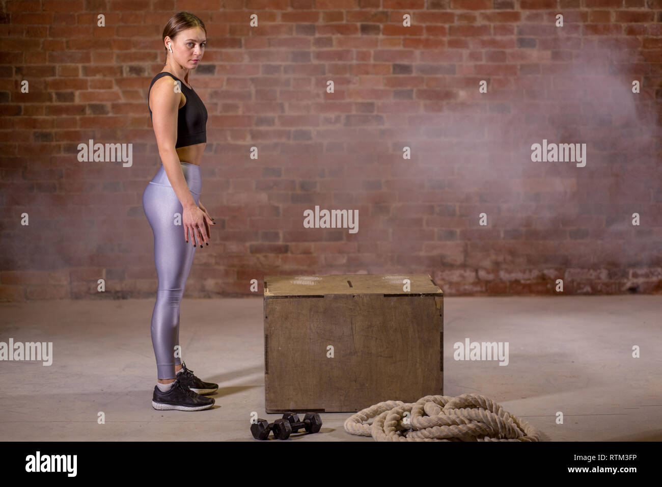 Female sportswoman prepares to plyo jump on gymnastics stand. Muscular ...