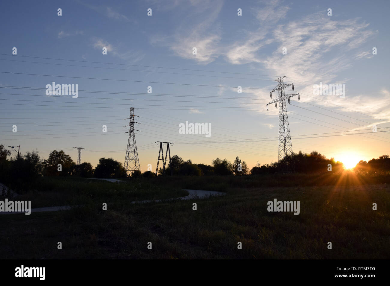 Electric poles on sunset Stock Photo - Alamy