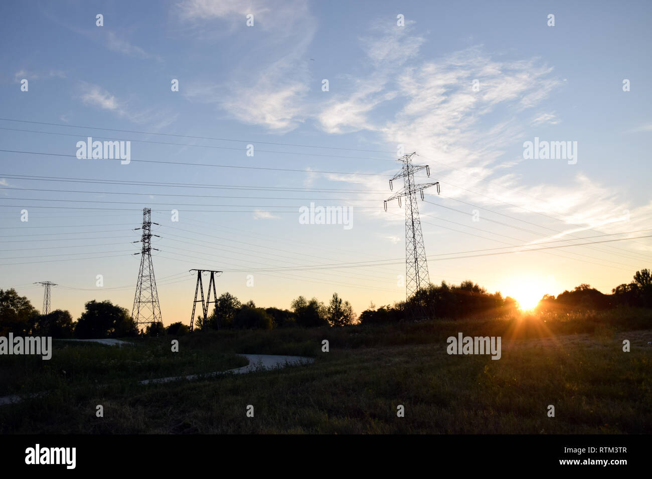 Electric poles on sunset Stock Photo - Alamy