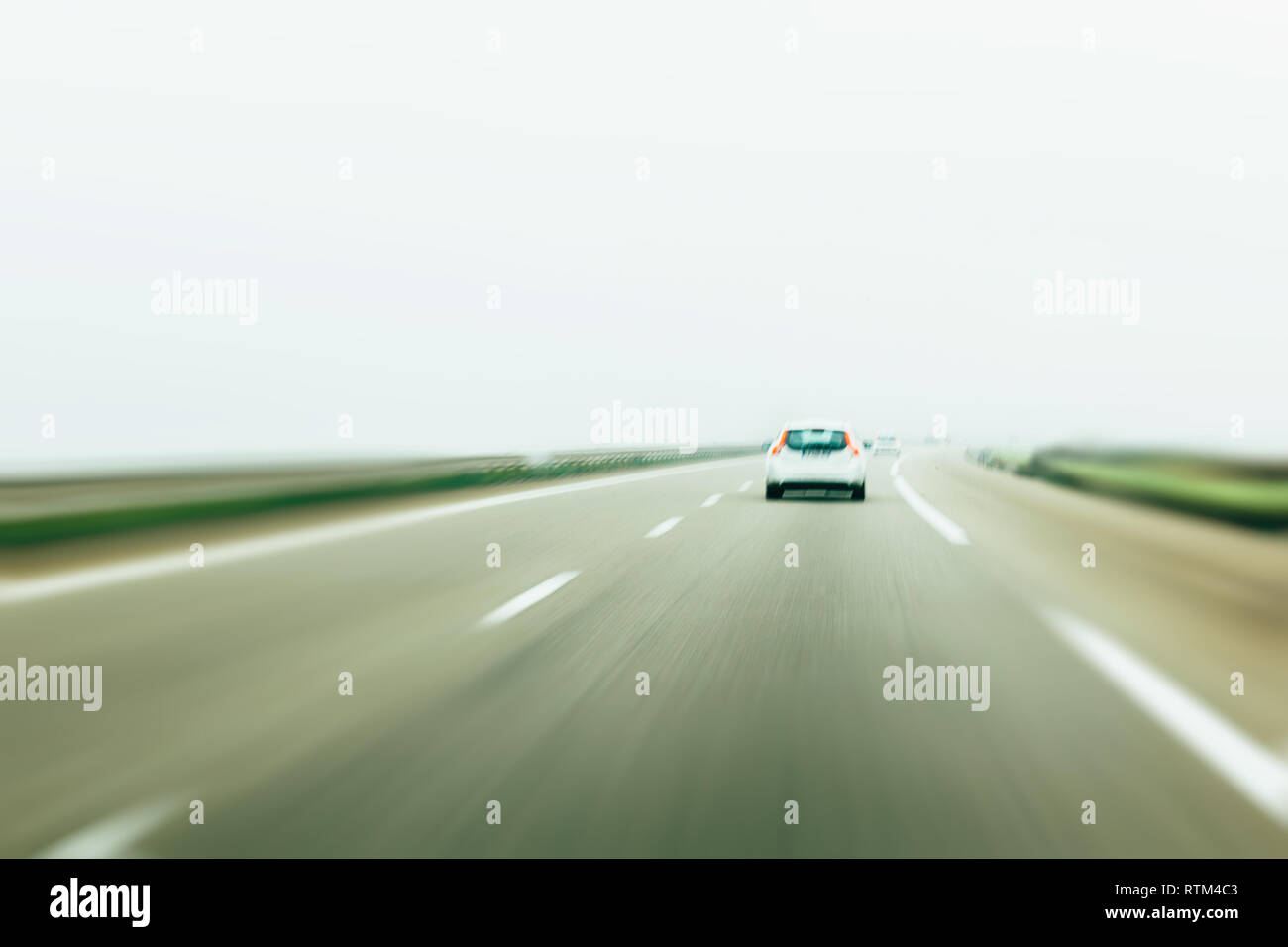 Rear view of white white car driving on German autobahn - fast motion ...