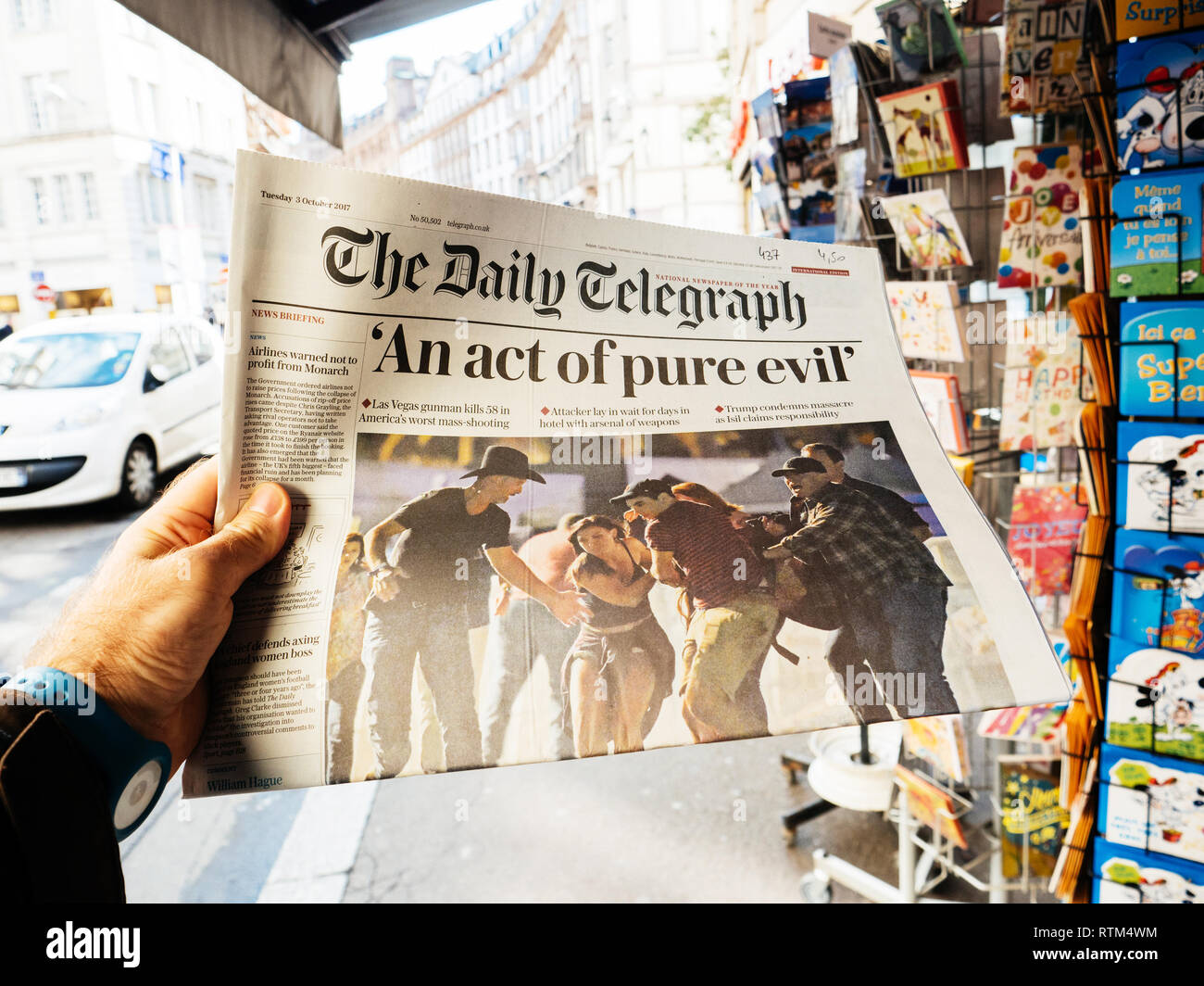 PARIS, FRANCE - OCT 3, 2017: Man buying The Daily Telegraph newspaper ...