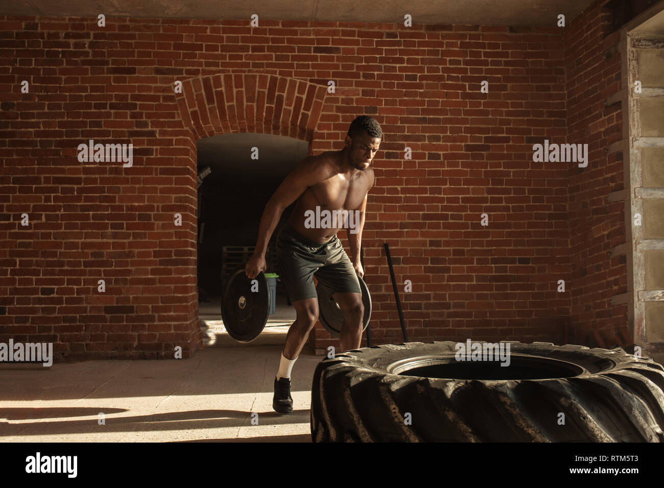 Powerful strong african fighter boxer practicing Weighted Jumps with ...