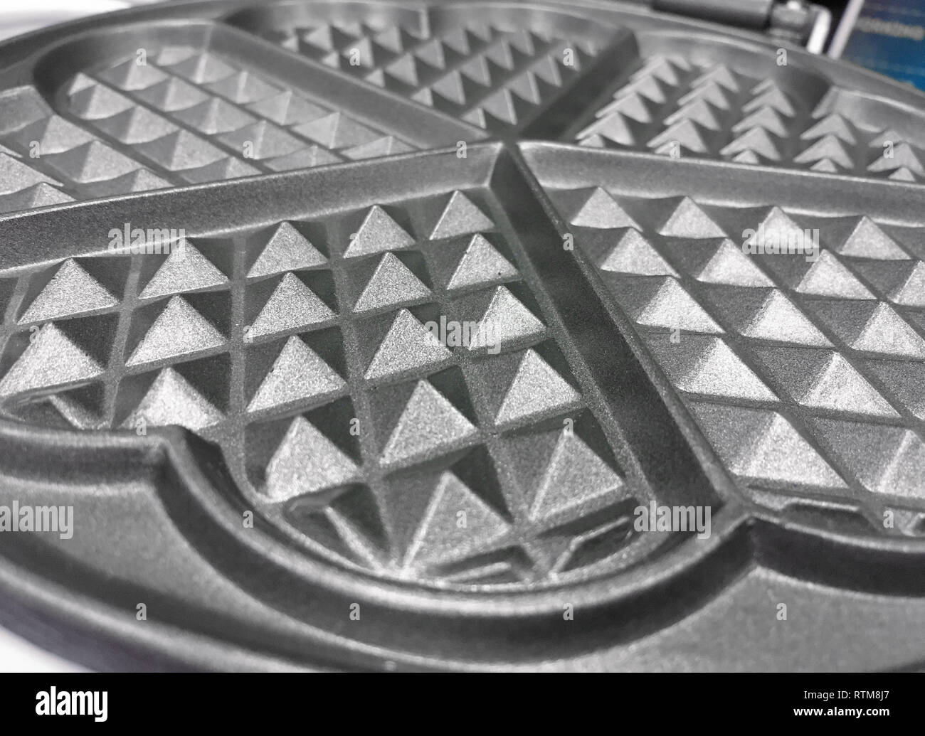 A close up shot of a silver waffle iron texture Stock Photo - Alamy