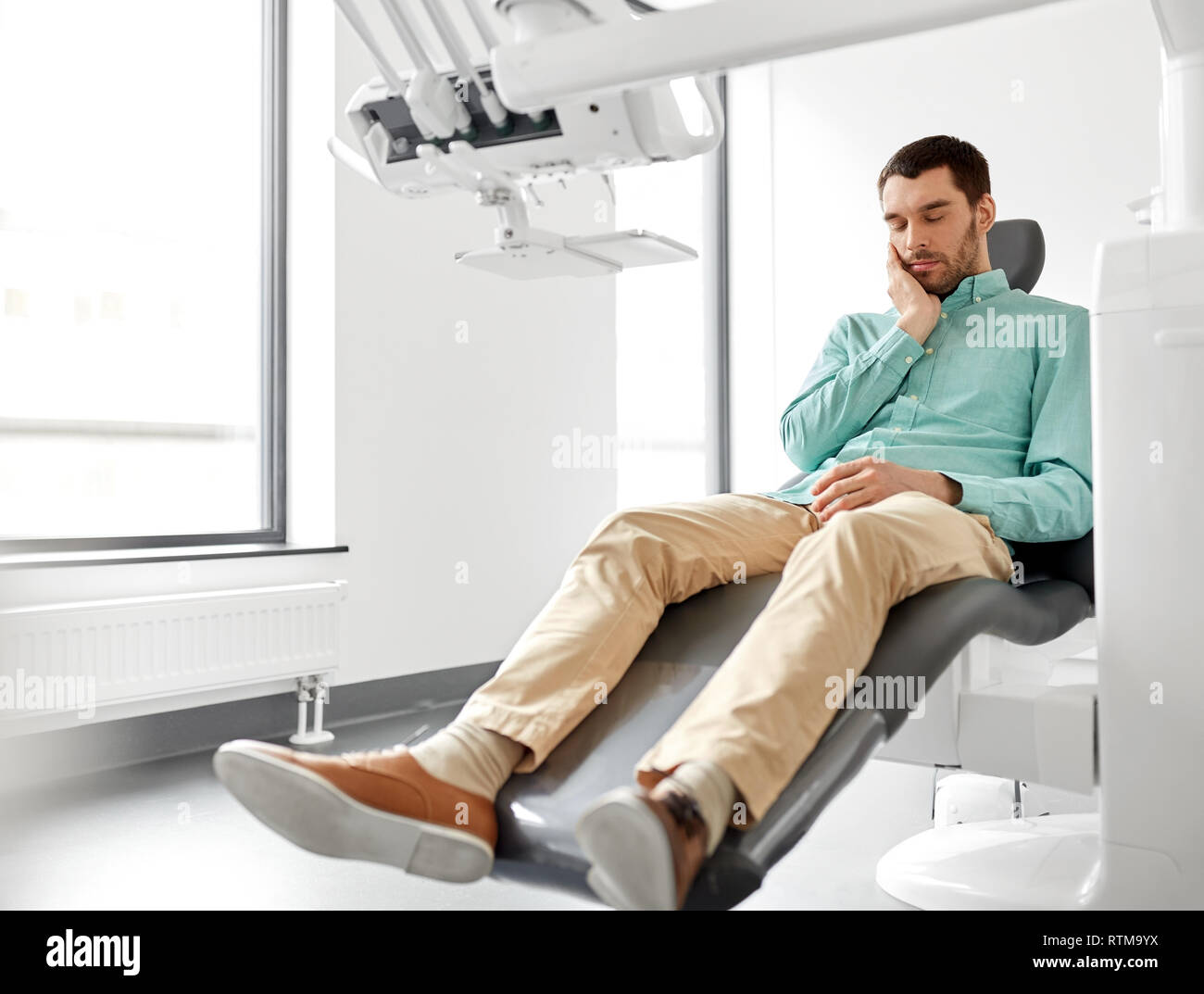 patient suffering from toothache at dental clinic Stock Photo - Alamy