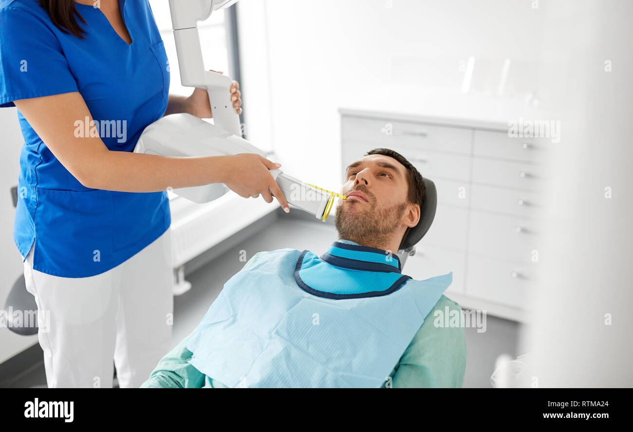 dentist making dental x-ray of patient teeth Stock Photo - Alamy