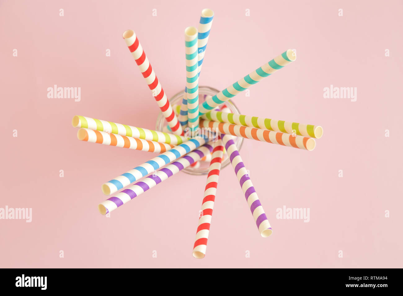 Colorful drinking straws against pastel pink background minimal ...
