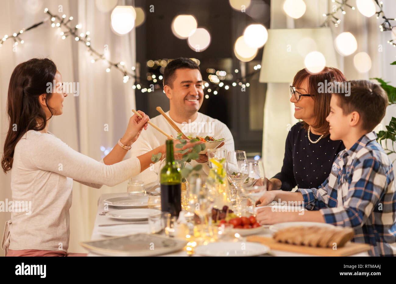 happy family having dinner party at home Stock Photo - Alamy