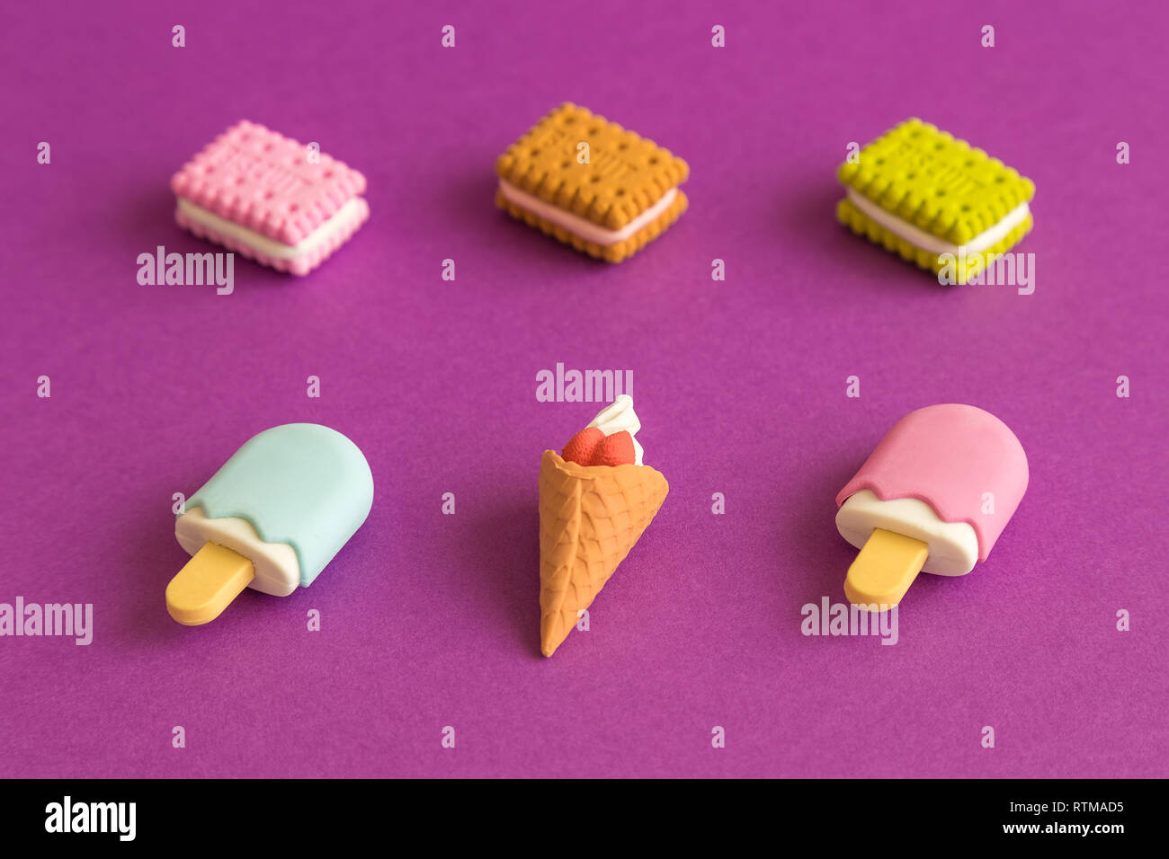 Miniature ice cream and biscuits on purple background minimal sweet ...