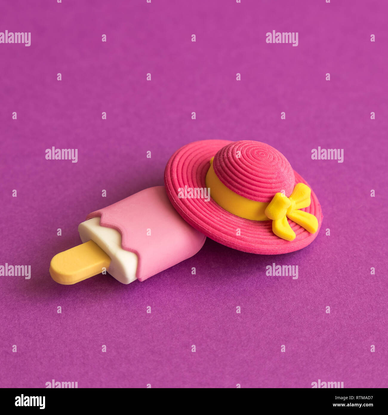 Ice cream and sun hat miniatures on purple background minimal summer ...