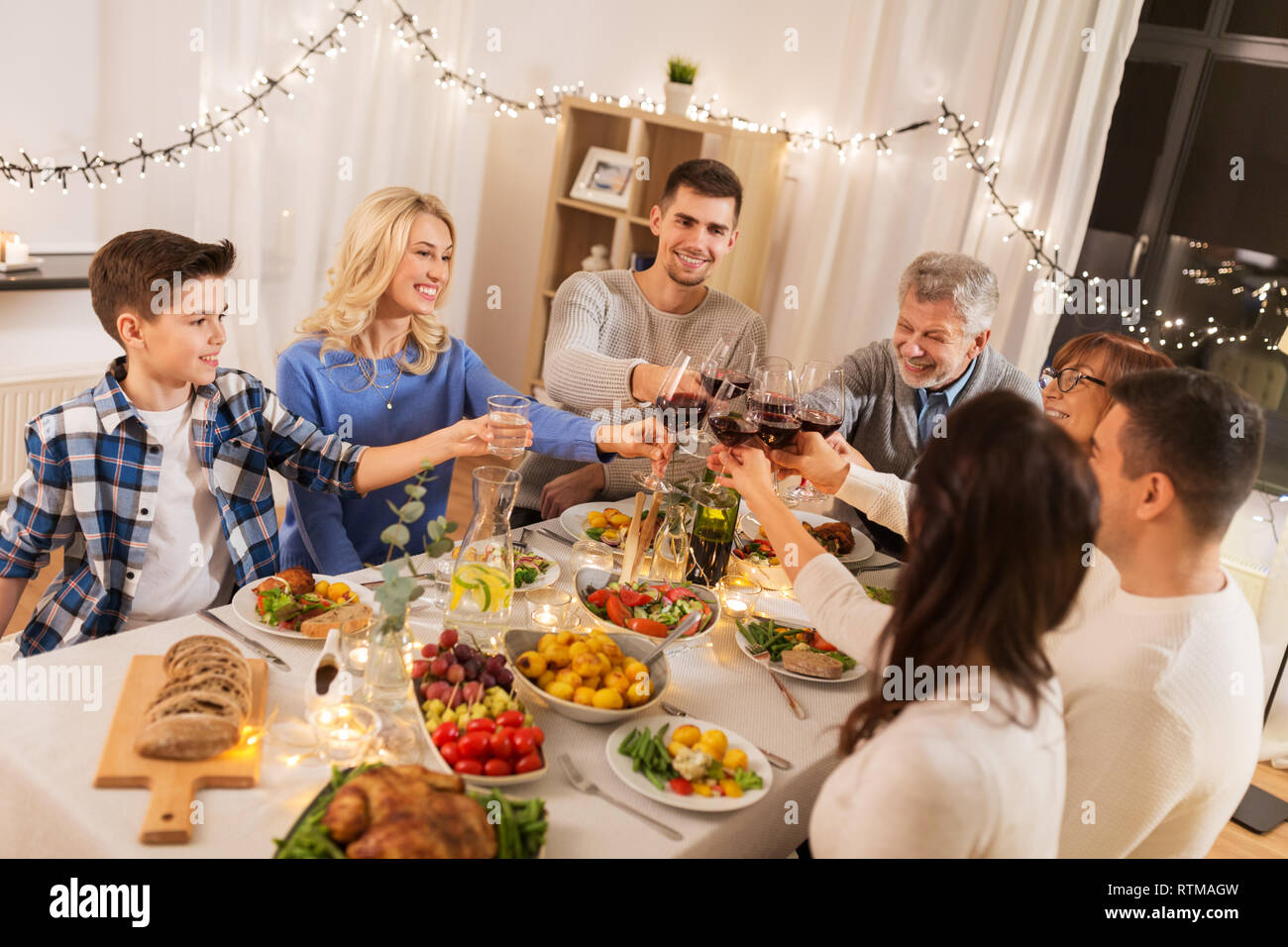 happy family having dinner party at home Stock Photo - Alamy