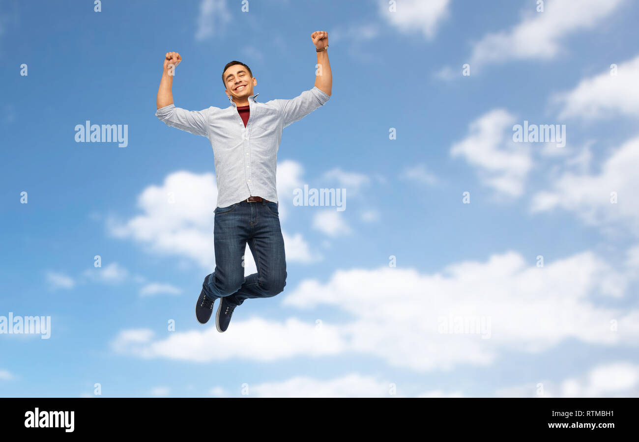 happy young man jumping over white background Stock Photo - Alamy