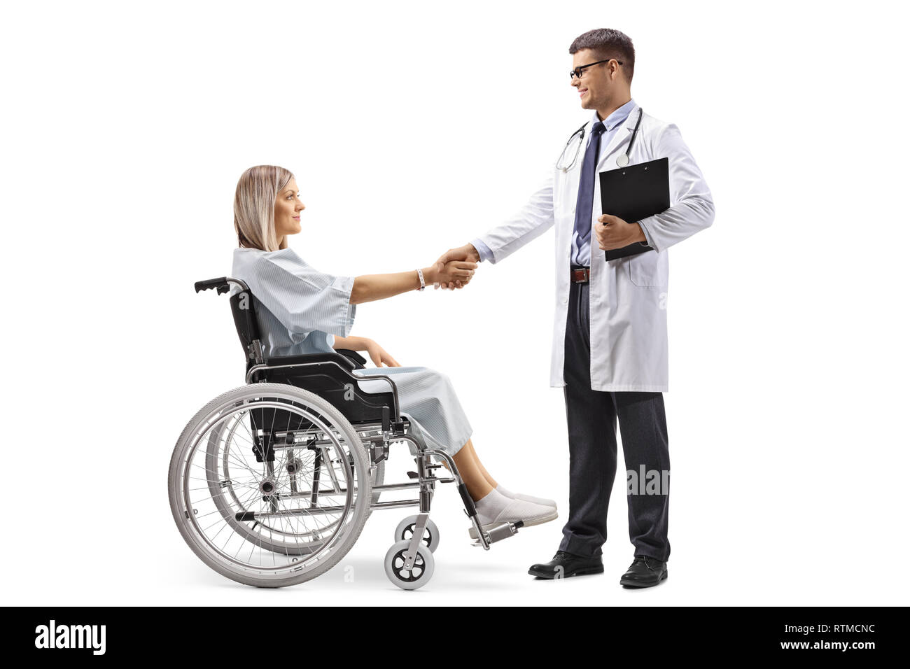 Full length shot of a young female patient in a wheelchair shaking ...