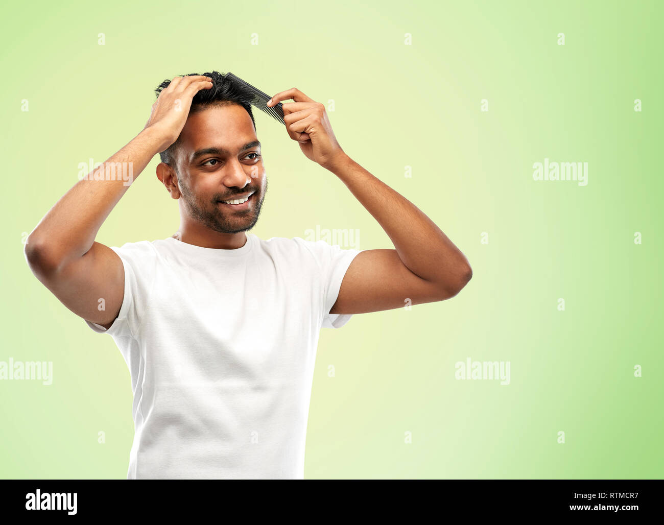 happy indian man brushing hair with comb Stock Photo - Alamy