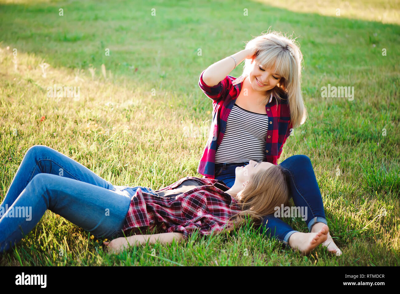 Two happy female friends playing and having fun in green grass Stock ...