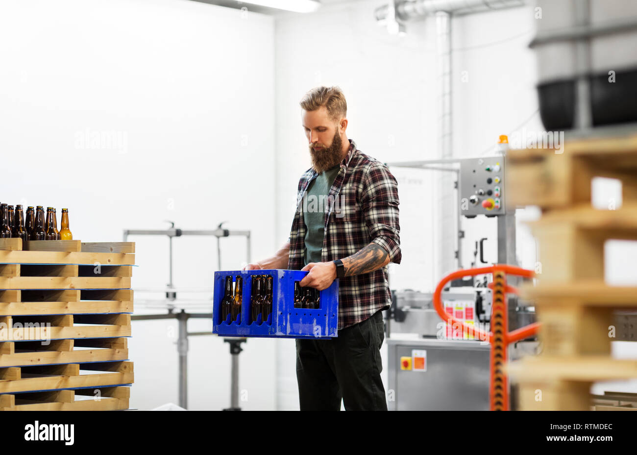 man with bottles in box at craft beer brewery Stock Photo - Alamy