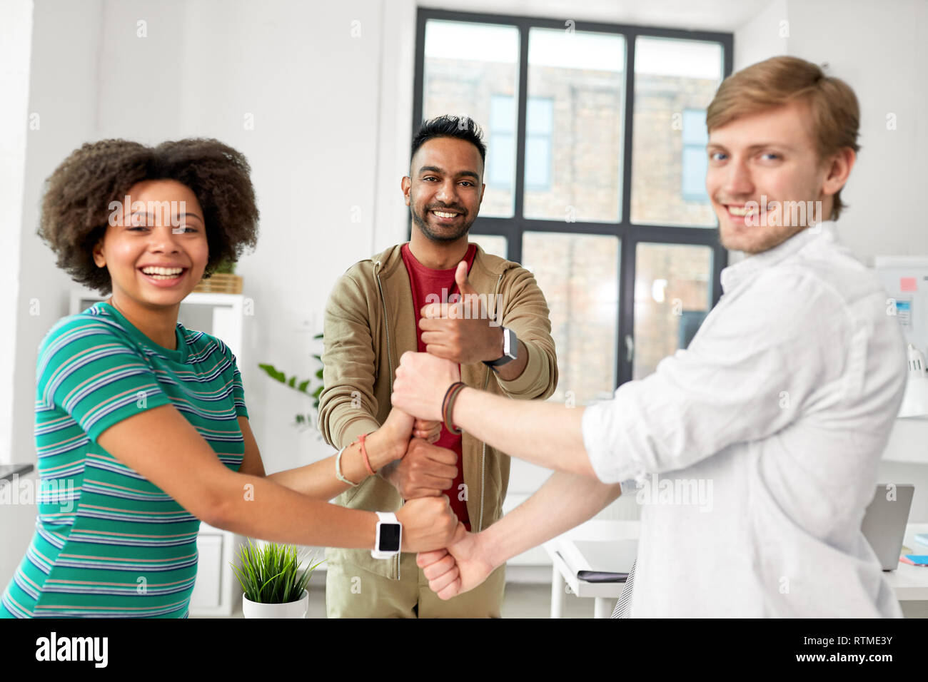 happy creative team making high five at office Stock Photo - Alamy