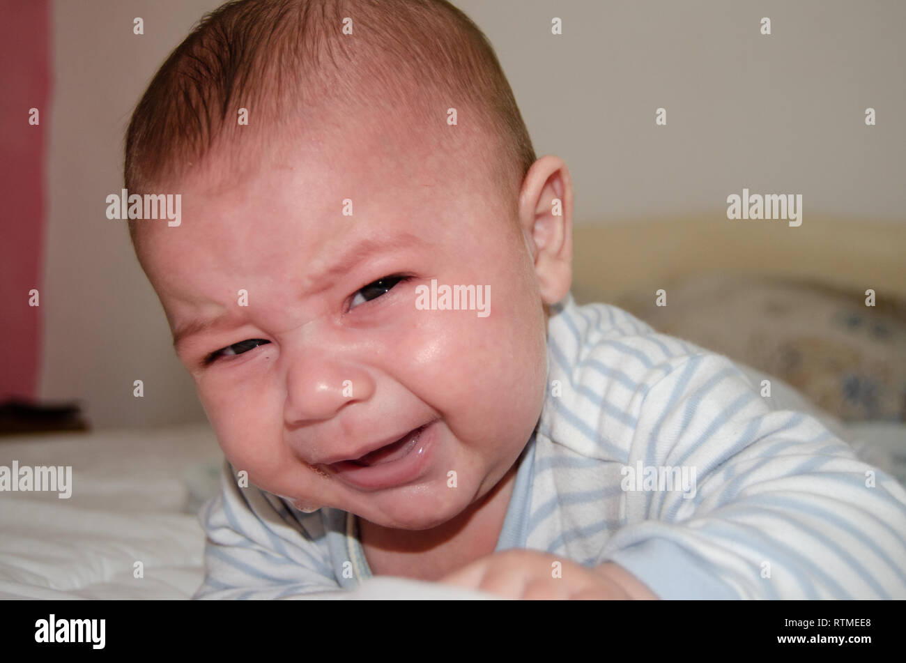 cute 4 months old baby boy got tired of tummy time and starting to cry ...