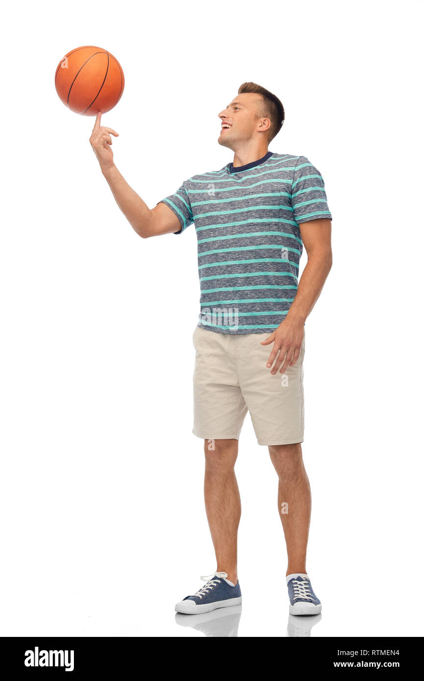 smiling young man spinning ball on finger Stock Photo - Alamy