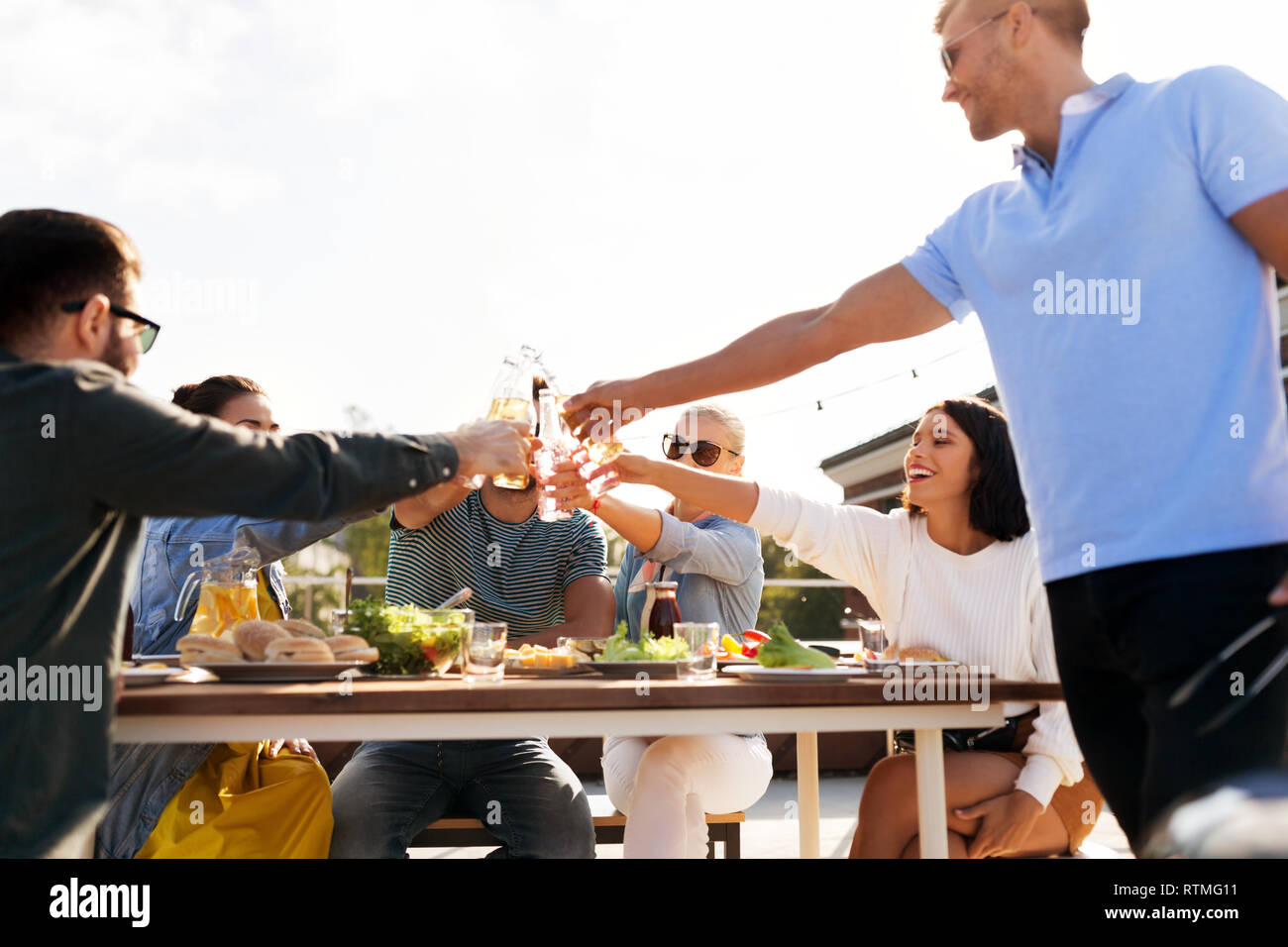 happy friends toasting drinks at rooftop party Stock Photo - Alamy