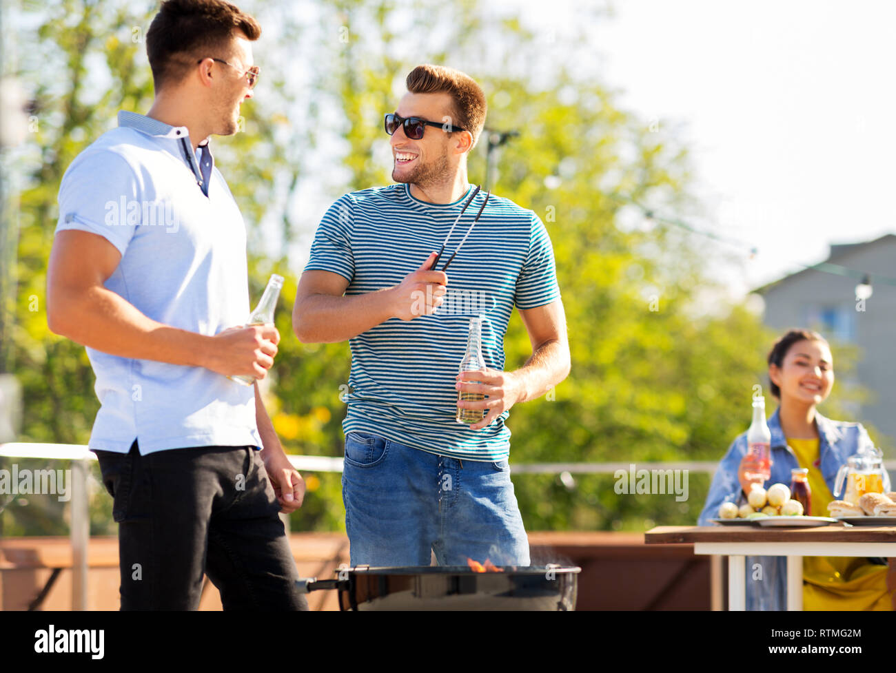happy friends having bbq party on rooftop Stock Photo - Alamy
