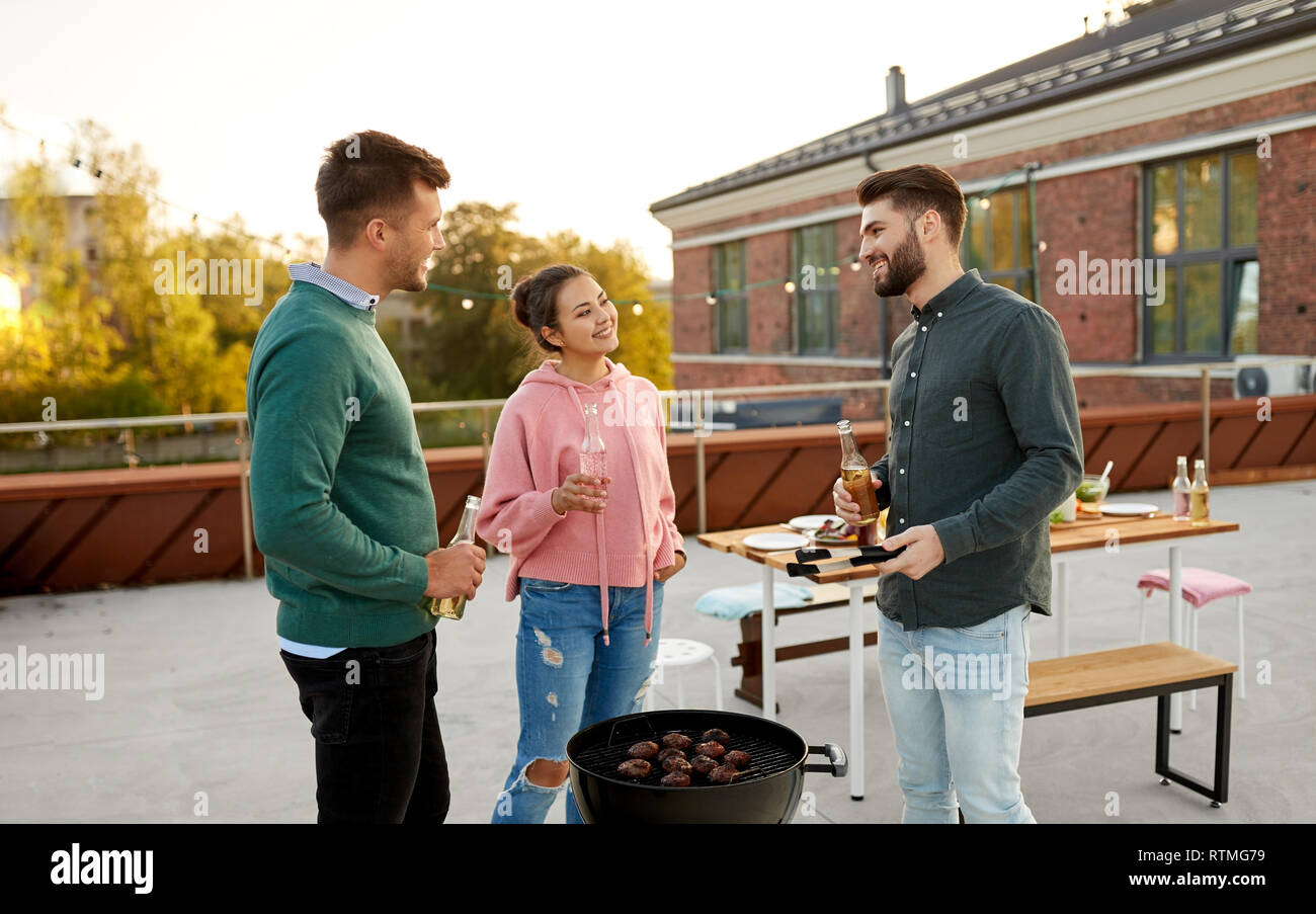 happy friends having bbq party on rooftop Stock Photo - Alamy