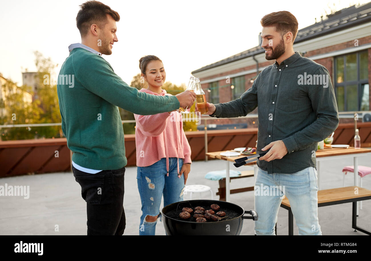 friends toast drinks at barbecue party on rooftop Stock Photo - Alamy