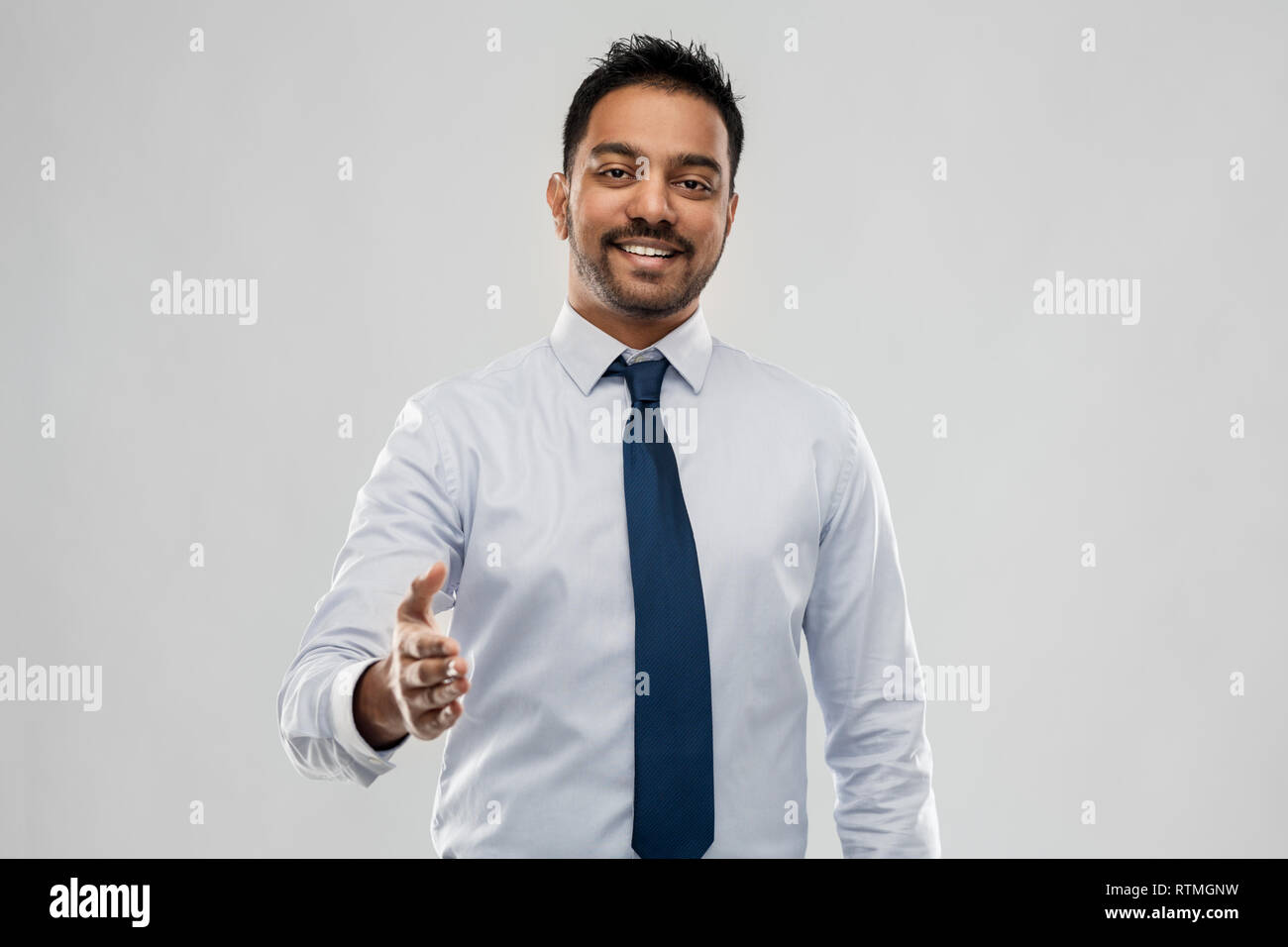 indian businessman stretching hand for handshake Stock Photo - Alamy