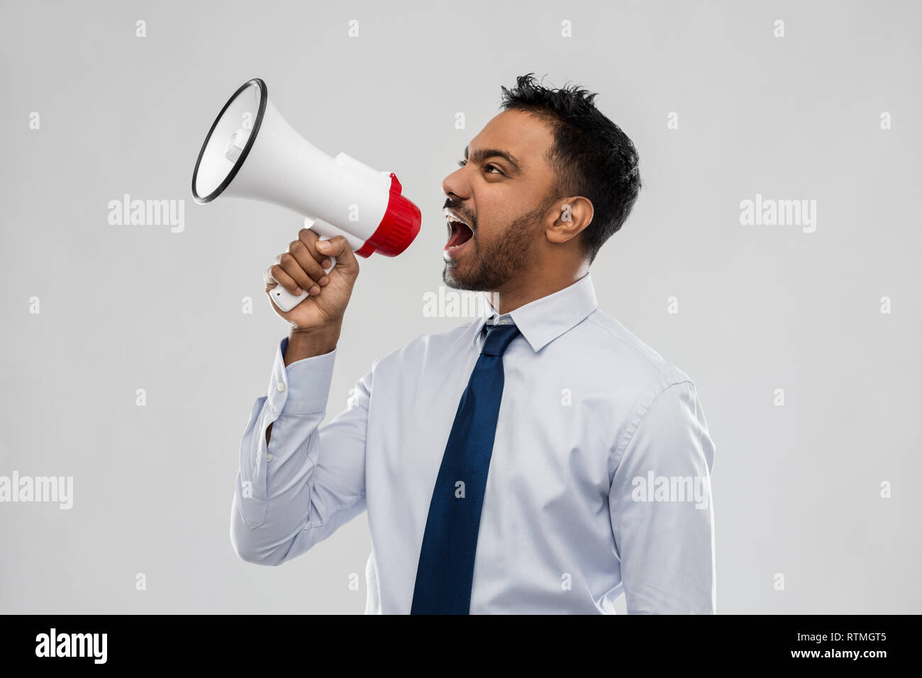 indian businessman screaming over grey Stock Photo - Alamy