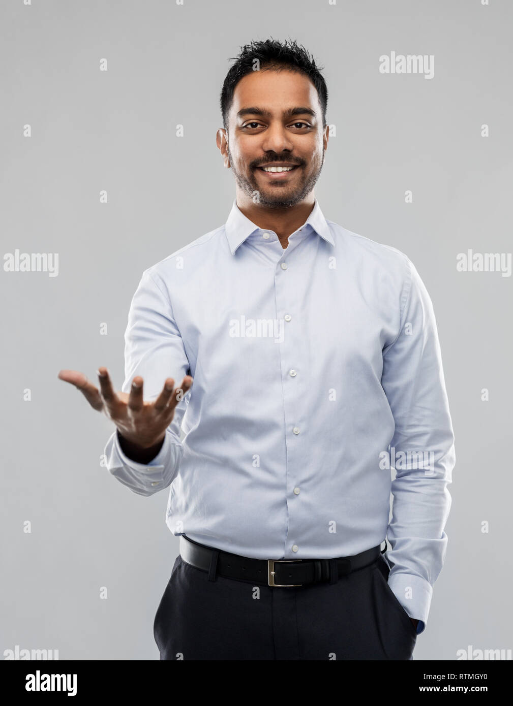 indian businessman holding something invisible Stock Photo - Alamy