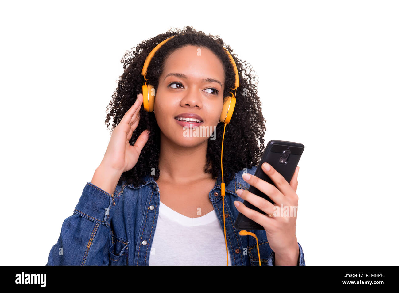 Beautiful young african woman listening to music, isolated over white ...