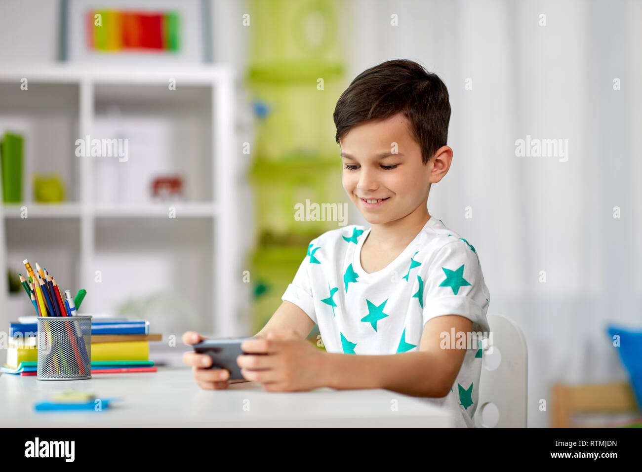 happy boy with smartphone at home Stock Photo - Alamy