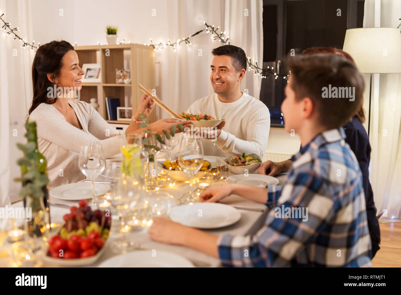 happy family having dinner party at home Stock Photo - Alamy