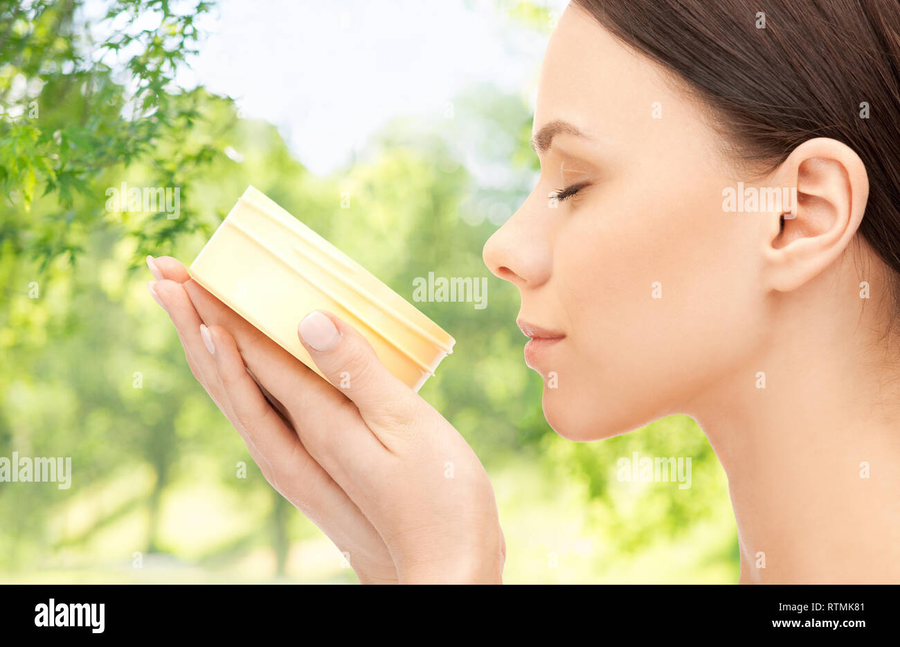 beautiful woman smelling moisturizing cream aroma Stock Photo - Alamy